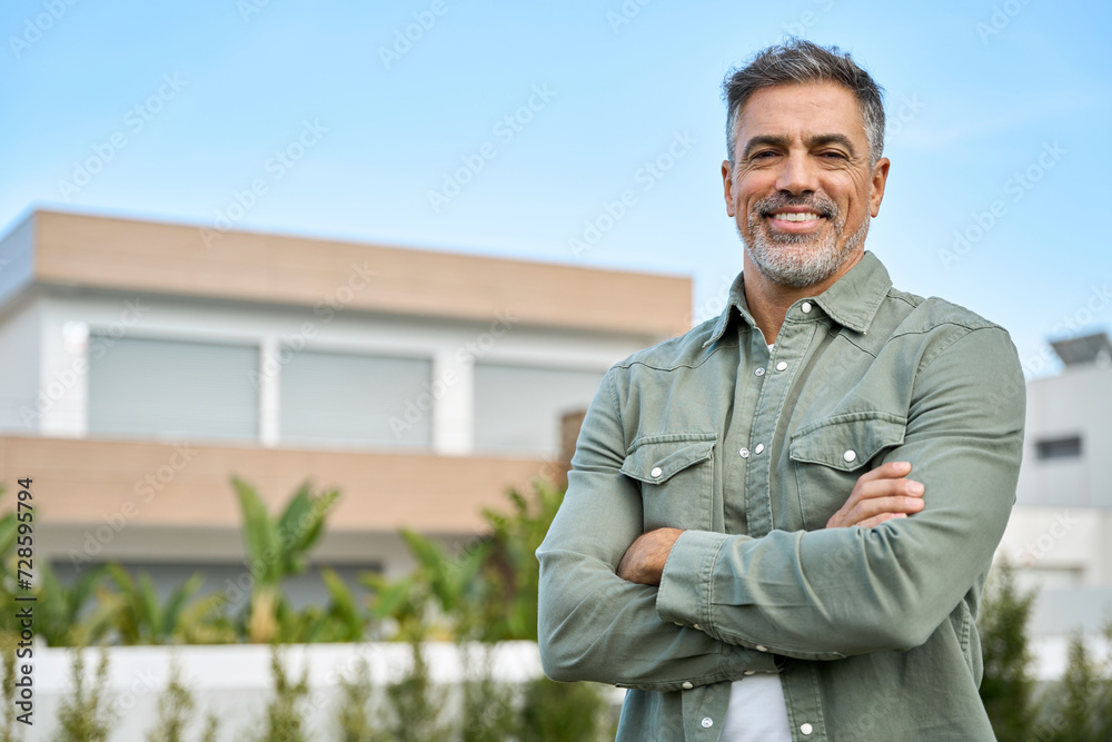 Happy mature older Latin man new property buyer modern villa owner or ...