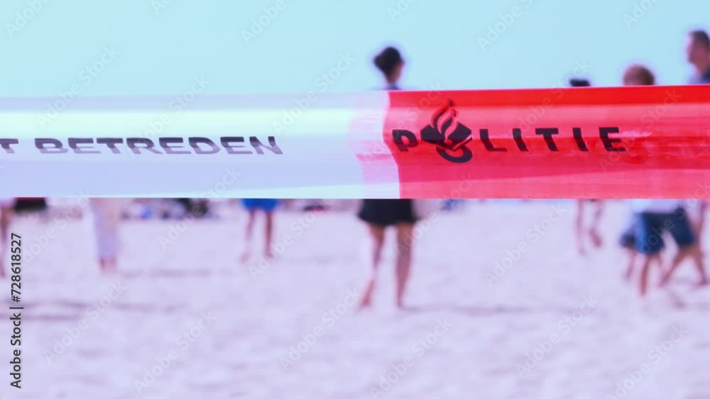 Crime scene on sandy beach marked with red and white police tape ...