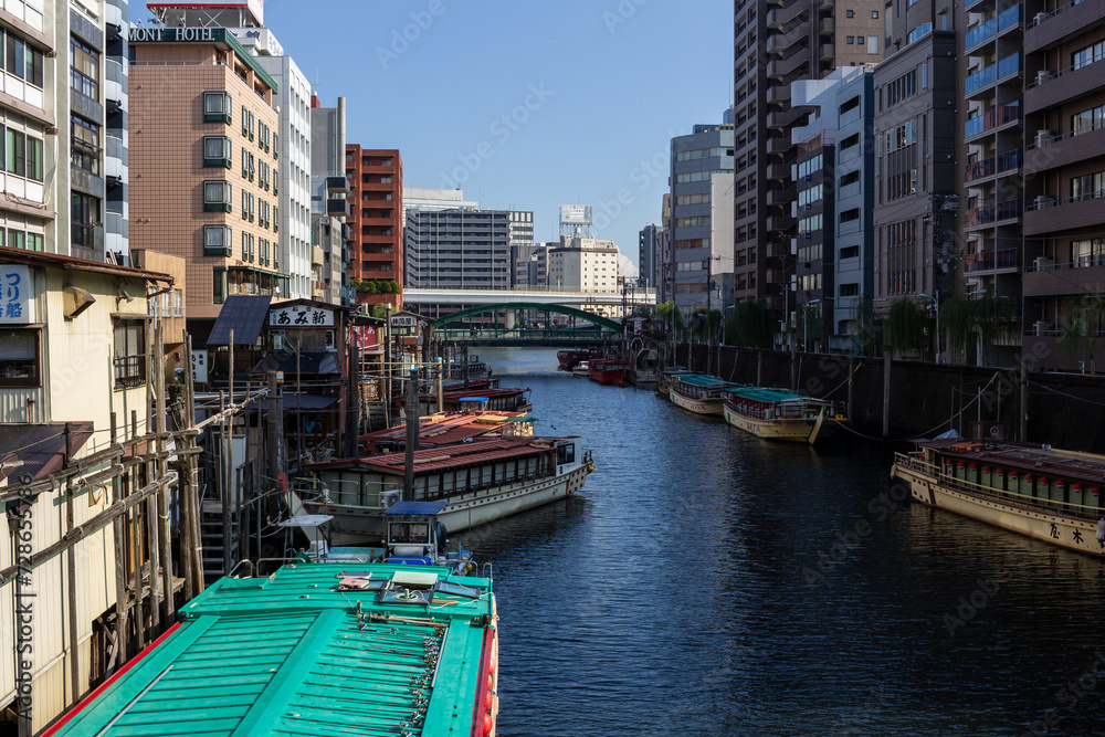 Tokyo, Japan, 1 November 2023: View of Kanda river with boats and city ...