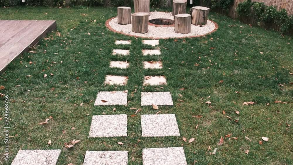 Tree stumps around fire pit with smoke rising from the burning logs ...