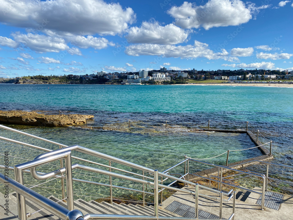 Public tidal pool near the ocean. Swimming pool on the shore. Metal ...
