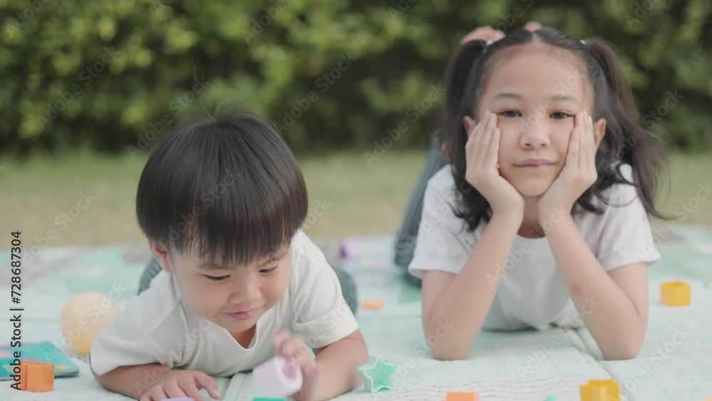 Close up smiling faces of two adorable asian kids, brother and sister ...