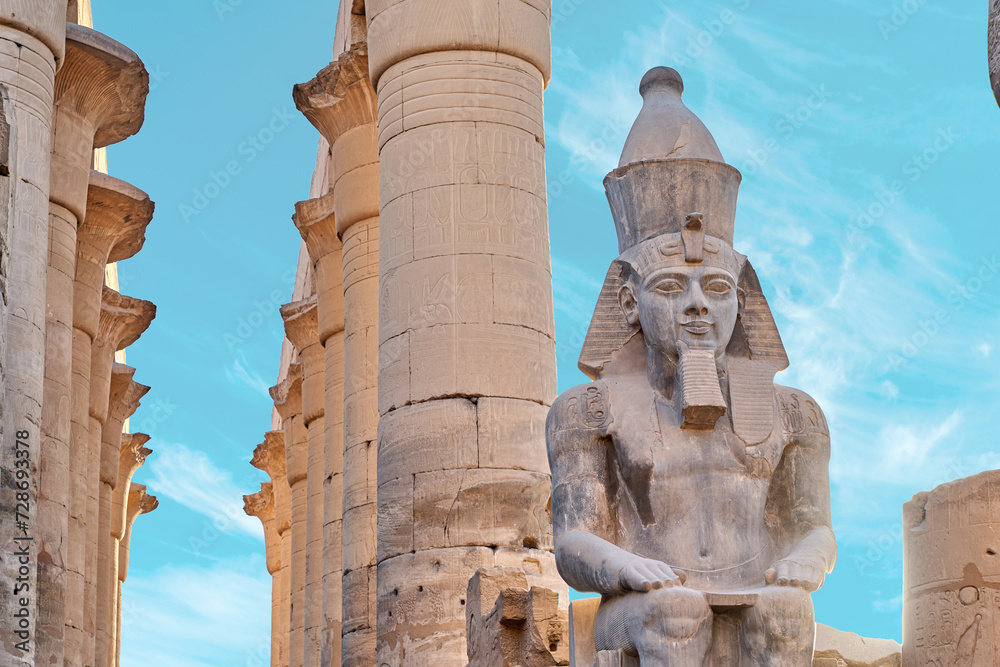 Seated statue of Ramesses II by the First pylon of the Luxor Temple ...