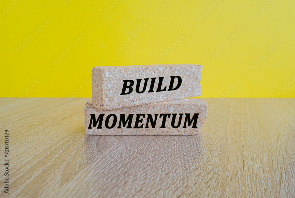 Build momentum symbol. Concept words Build momentum on brick blocks ...