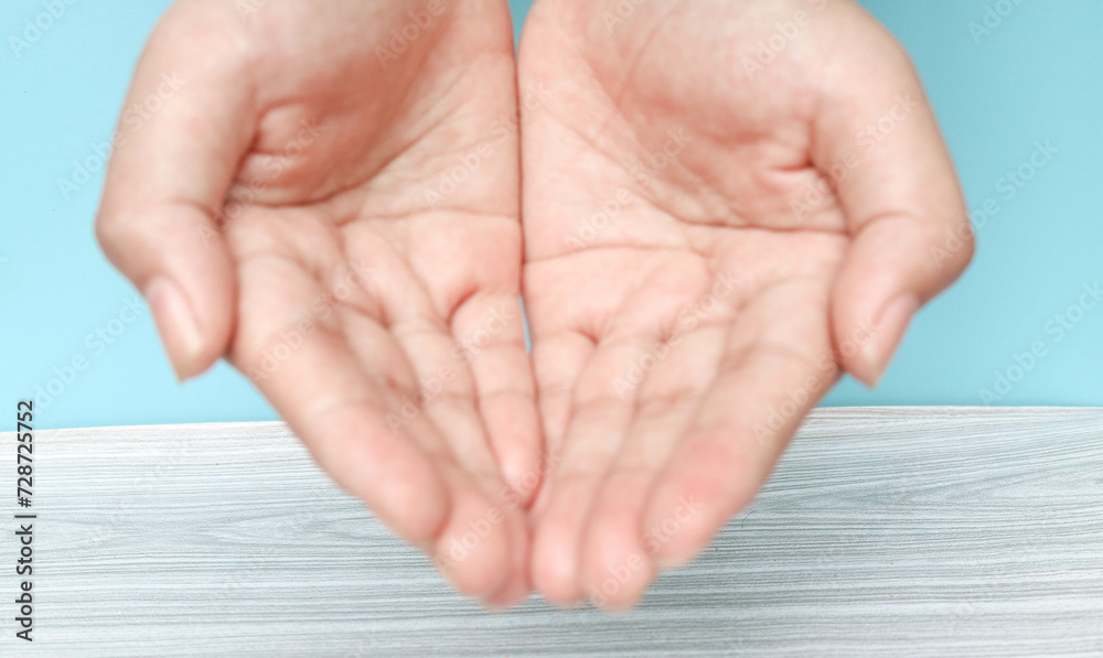 Empty cupped palm hands, keeping hands together isolated on light blue ...