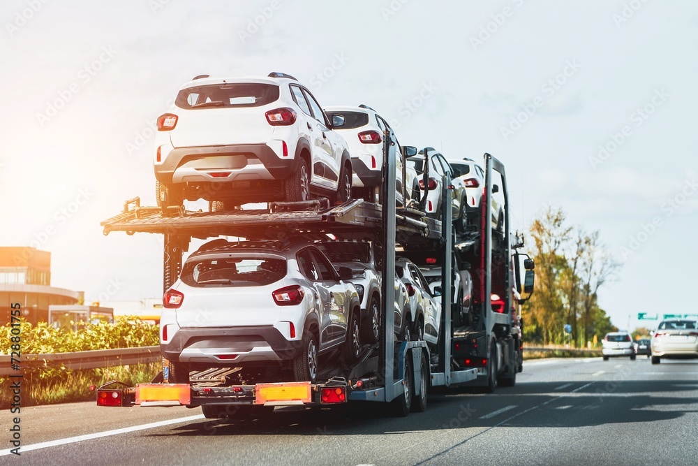 Car dealership delivery. New cars on a hydraulic trailer are ready for ...
