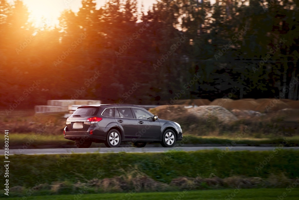 Driving a modern car in the golden hour of dusk. A scenic landscape of ...