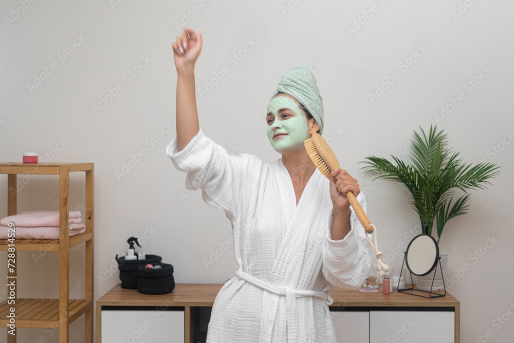 Home Spa Jam: In her bathrobe, she wears a clay mask, using a hairbrush ...