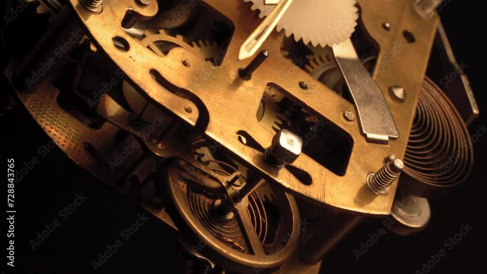 clockwork mechanism of an old ALARM CLOCK disassembled with golden ...