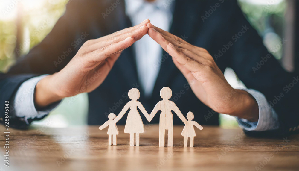 hand gesture shields wooden dominoes falling toward family dolls ...
