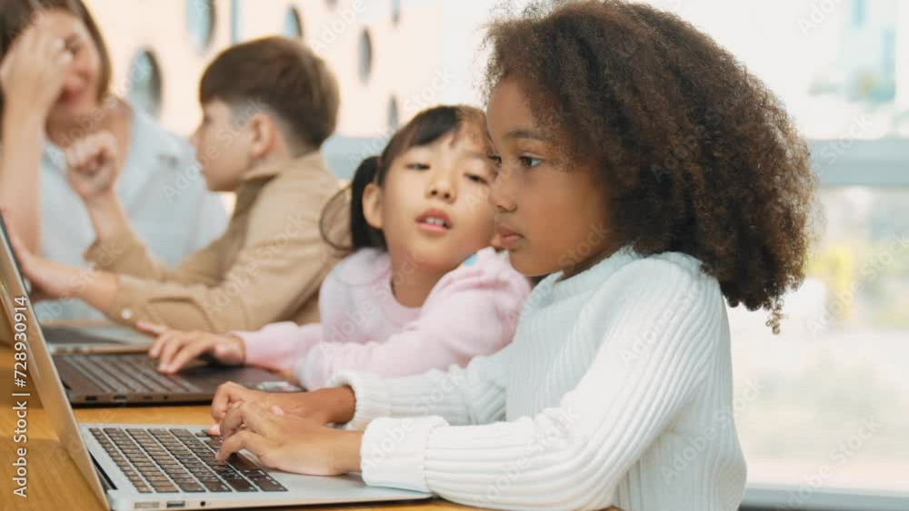 African girl play laptop with diverse friend learning prompt at STEM technology class ...