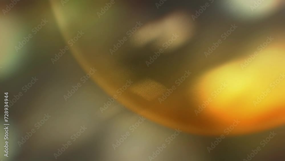 bokeh background of golden colors with light particles on a dark ...