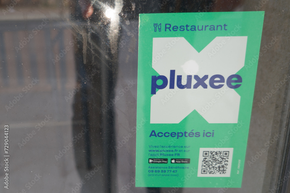 pluxee sodexo brand logo and text sign front of bar door window facade ...