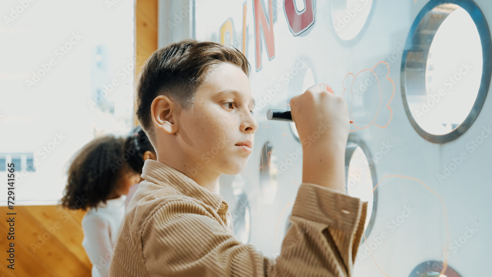 Closeup of caucasian creative student draw beautiful picture at glass ...