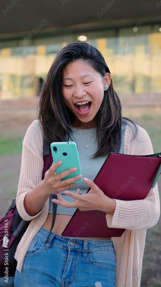 Chinese school girl smiling using a cellphone to share photos on the ...