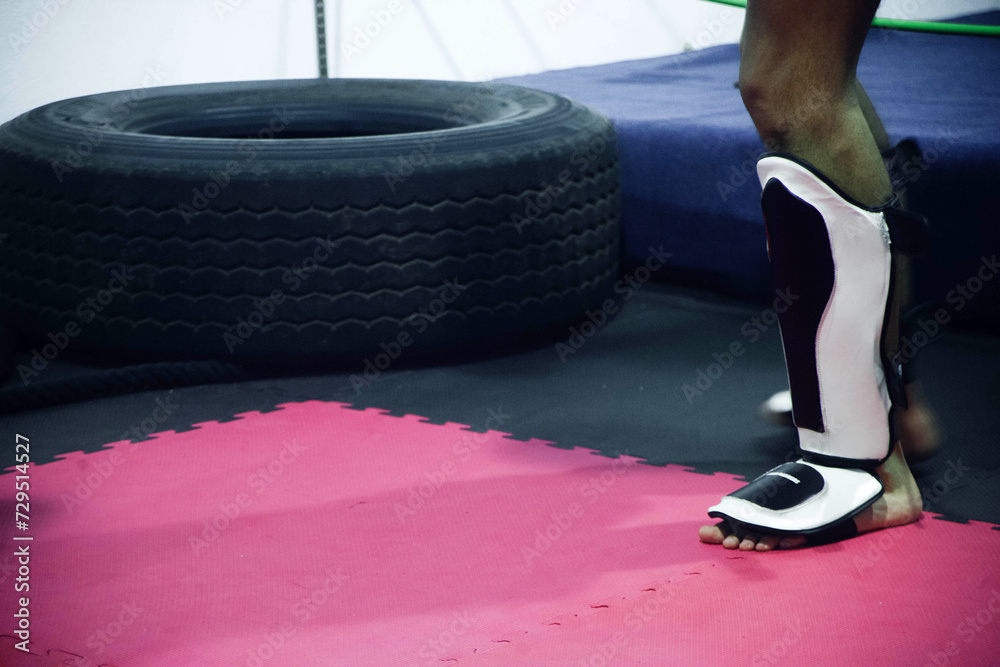 Powerful Muay Thai fighters' legs, shielded by shin guards, showcase ...