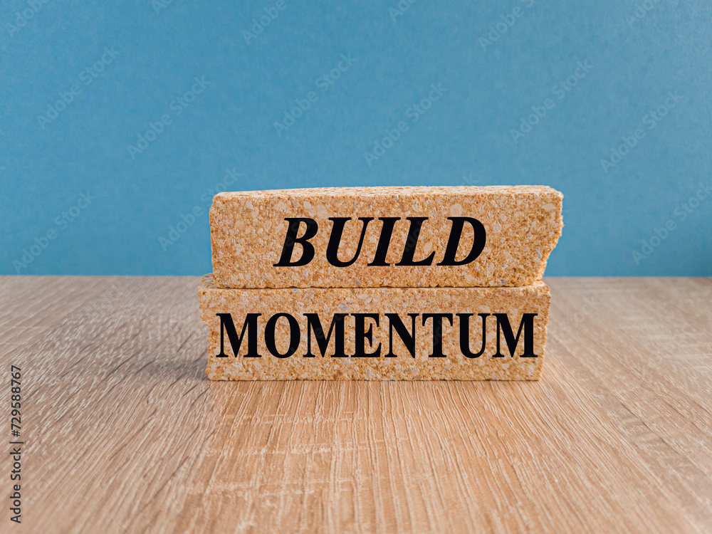 Build momentum symbol. Concept words Build momentum on brick blocks ...