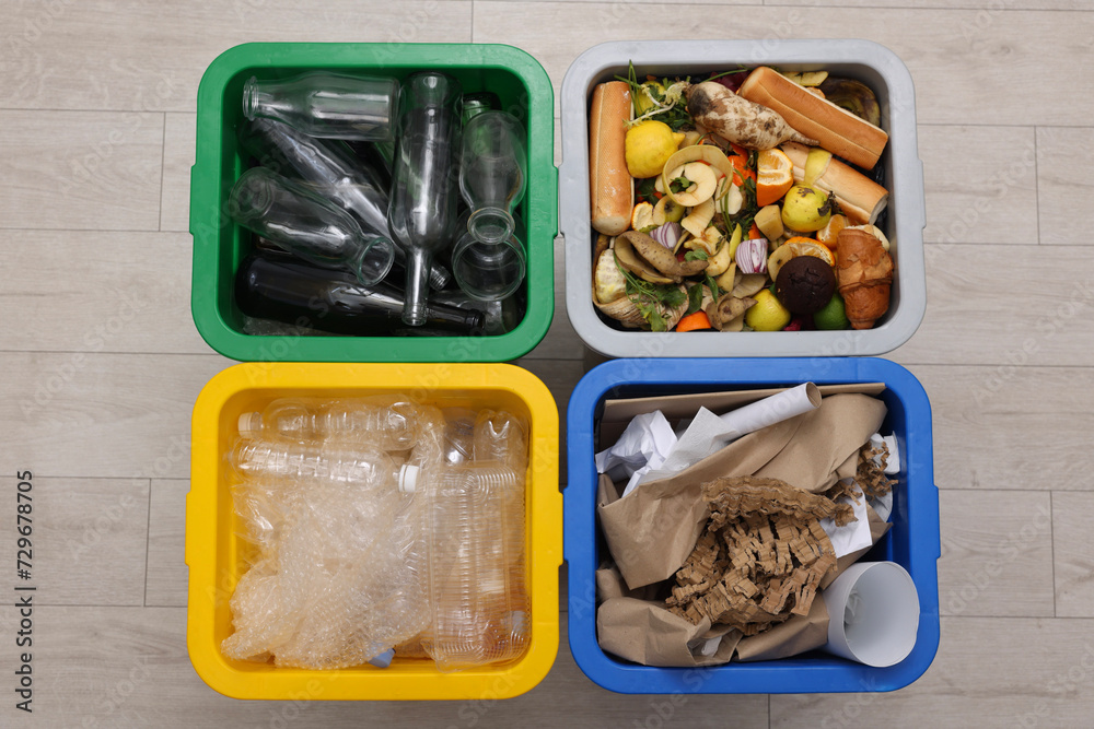 Garbage sorting. Full trash bins for separate waste collection indoors ...