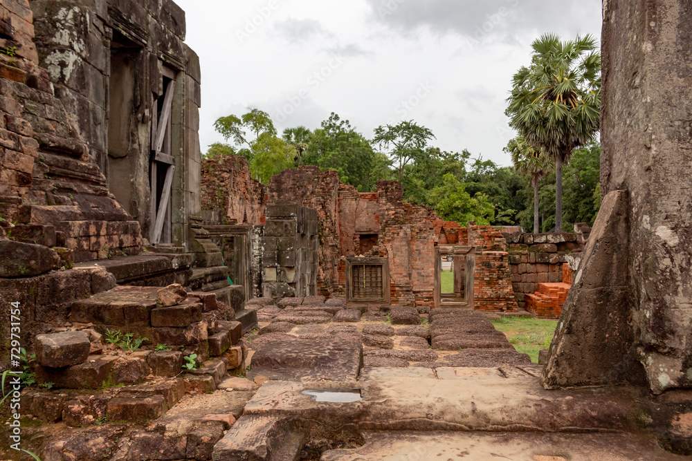 Stone brick temple ruin building complex walls and lush green rain ...