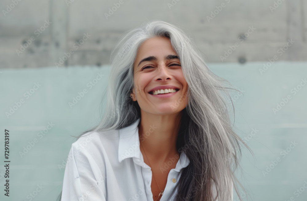 Vivacious Woman with Long Silver Hair Laughing Candidly in White Shirt ...