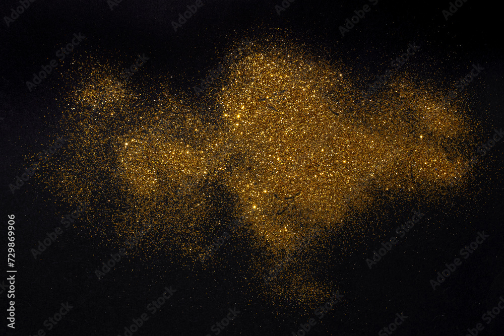 group of Golden flakes are scattered on the black surface. gold ...