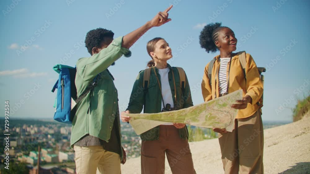 Camera view of group of multi-ethnic friends hiking together. Checking ...