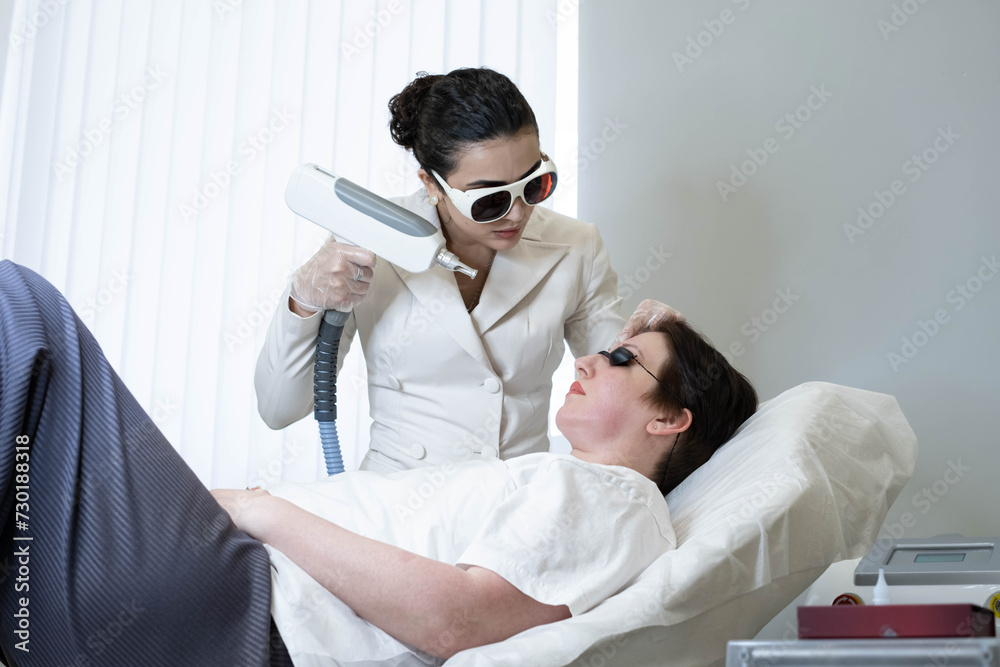 Clinician conducting a careful laser treatment, patient at ease ...