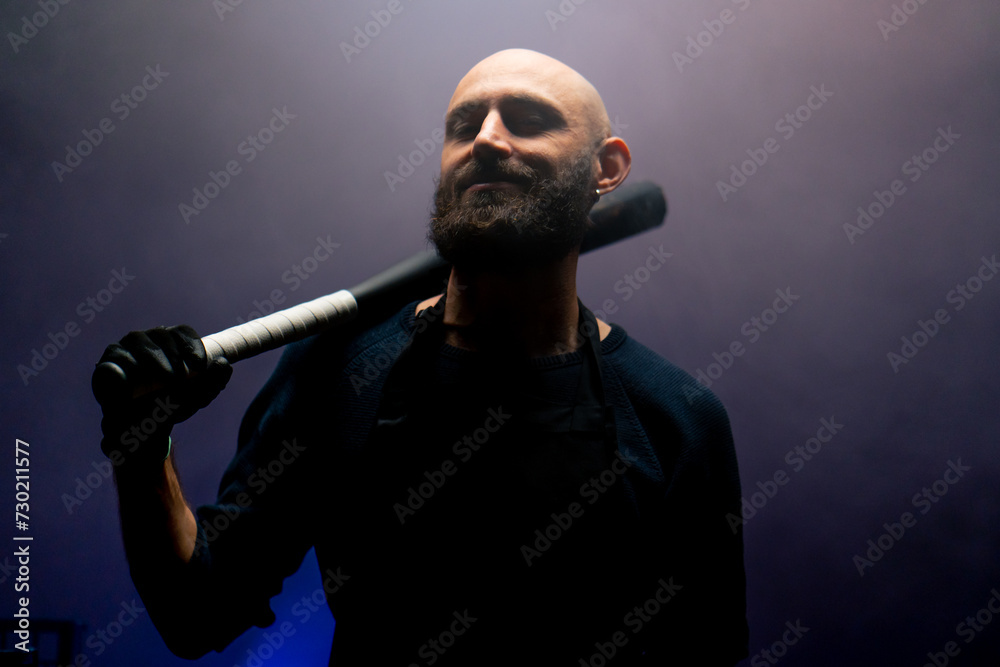 bald brazen robber with beard holding baseball bat during robbery ...
