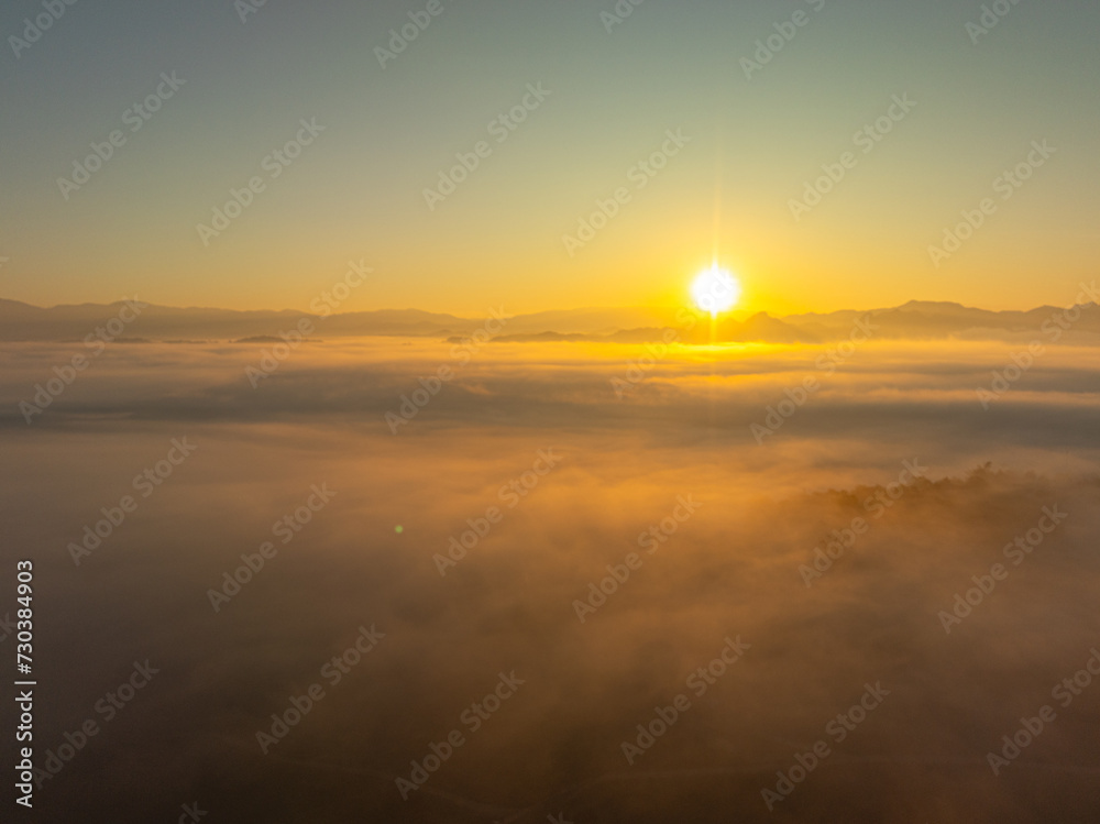 Aerial view scenery beautiful sunrise above the sea of mist in front ...