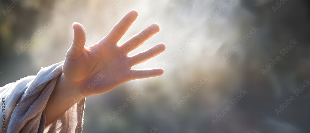 Jesus christ extending his hand in a warm environment trying to help ...