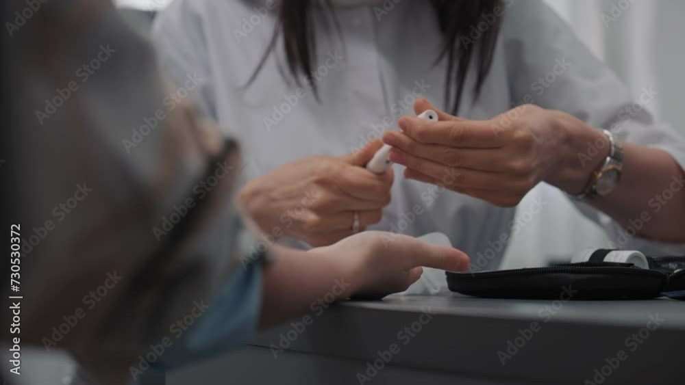Close up shot of female doctor, nurse taking blood test from finger of ...