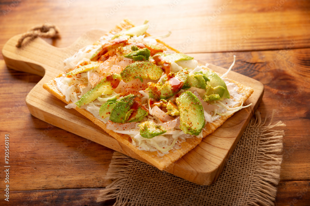 Fried wheat flour toast with pickled pork skin, sour cream and ...