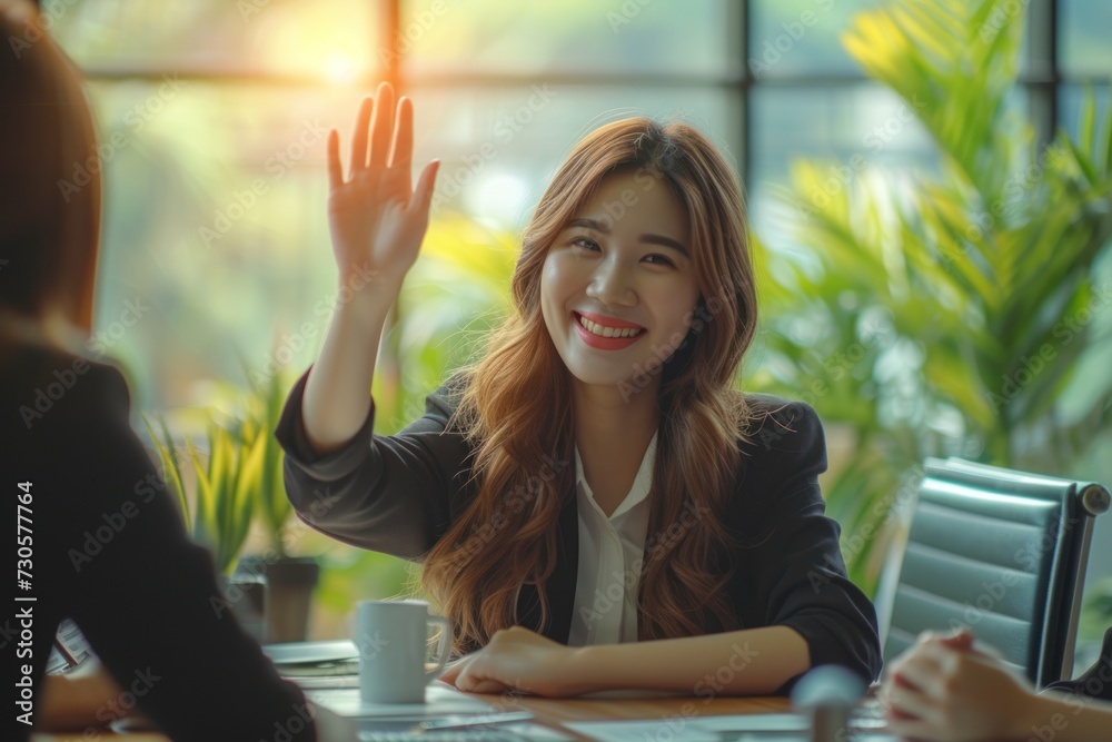 Businesswoman giving a high five to the colleague in meeting room ...