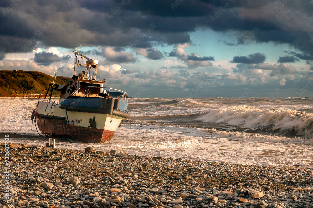 View of the beached ship. The wreck of a yacht in stormy weather. A ...