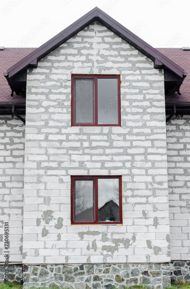 A house without a facade built from gas blocks. Construction concept. A ...