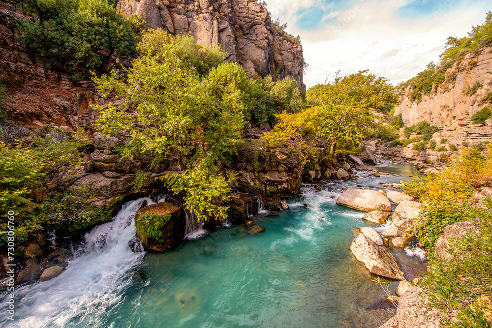 Transparent waters of Kopru River (Köprüçay, ancient Eurymedon) with ...
