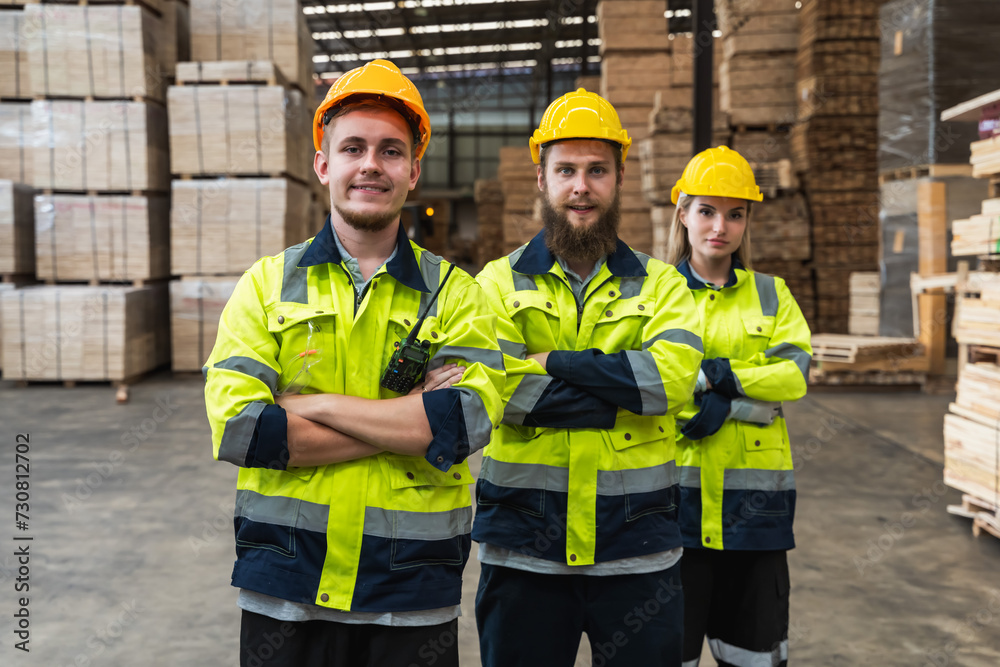 Young factory male and female workers standing arm crossed working in ...