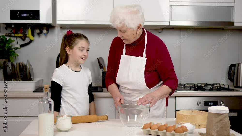 Grandma and granddaughter cooking at home. Preparation dough with ...