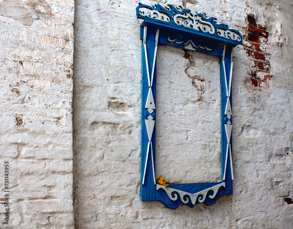 An antique window frame is attached to the wall as a museum piece. The ...