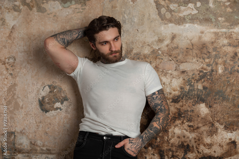 handsome muscular brutal hipster man with a hairstyle and beard with a ...