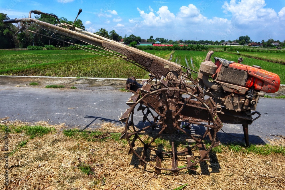 Hand tractor machine on the side of the road with a background of the ...