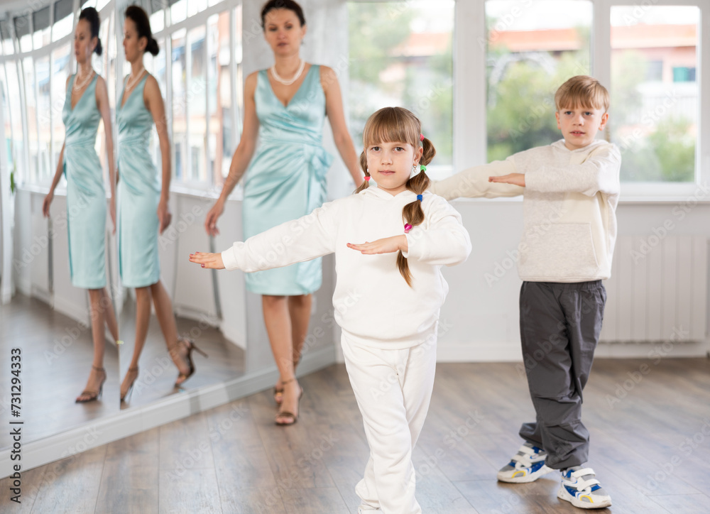 Boy and girl kids repeat movement while taking boogie woogie dancing ...