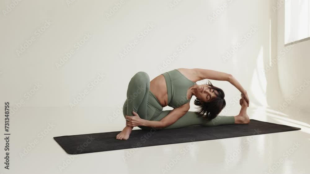 A dedicated female yogi showcases flexibility and strength while ...