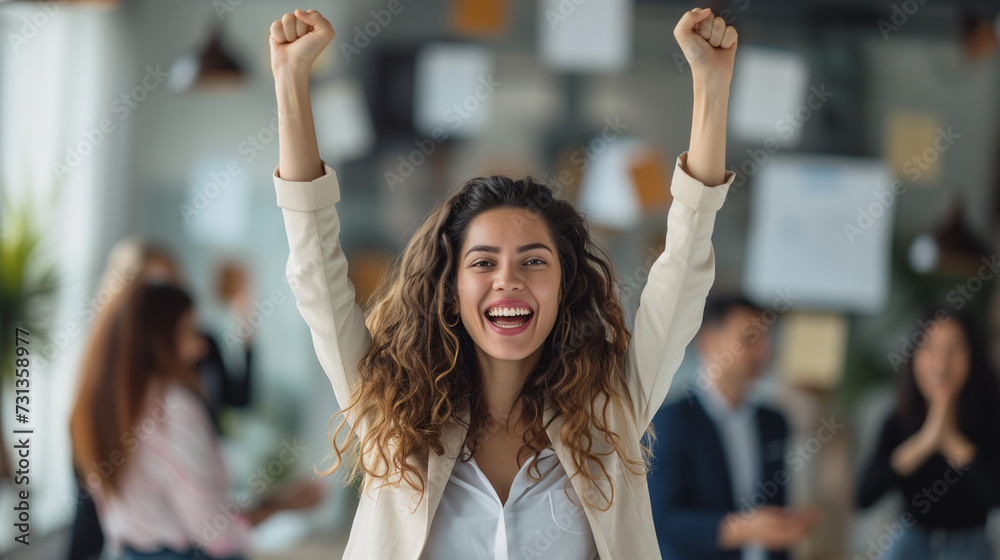 Exuberant woman celebrating with arms raised in an office setting Stock ...