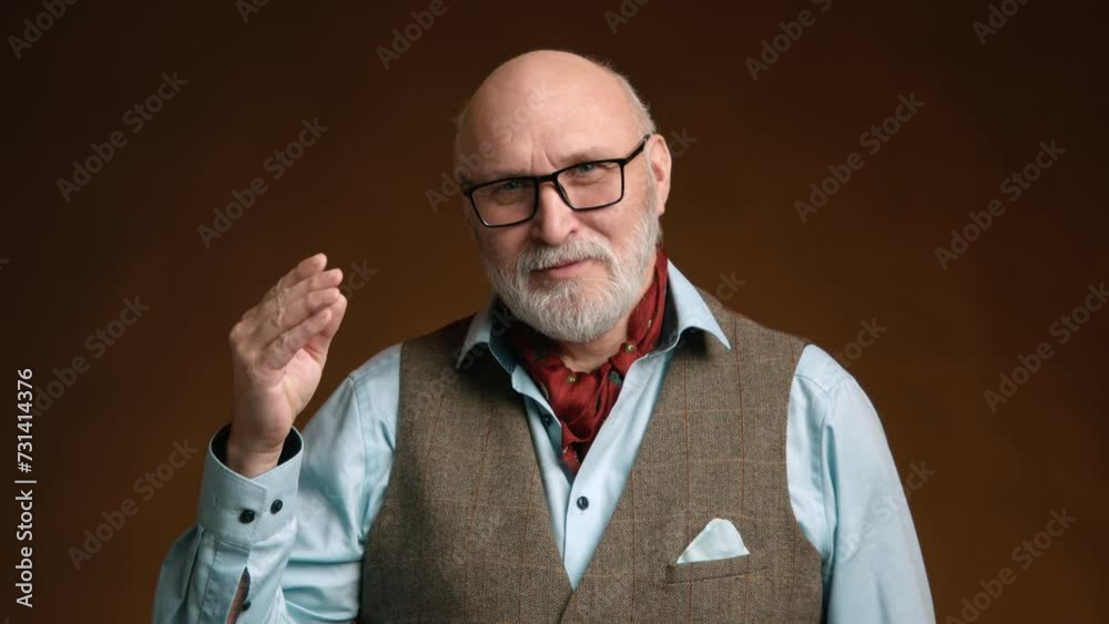 An expressive man in a tweed vest uses hand gestures to mimic the act ...