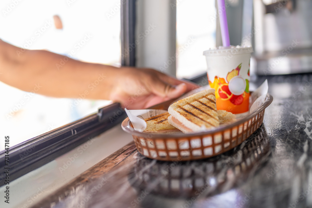 Man grabbing a sandwich and beverage in a food truck Stock Photo ...