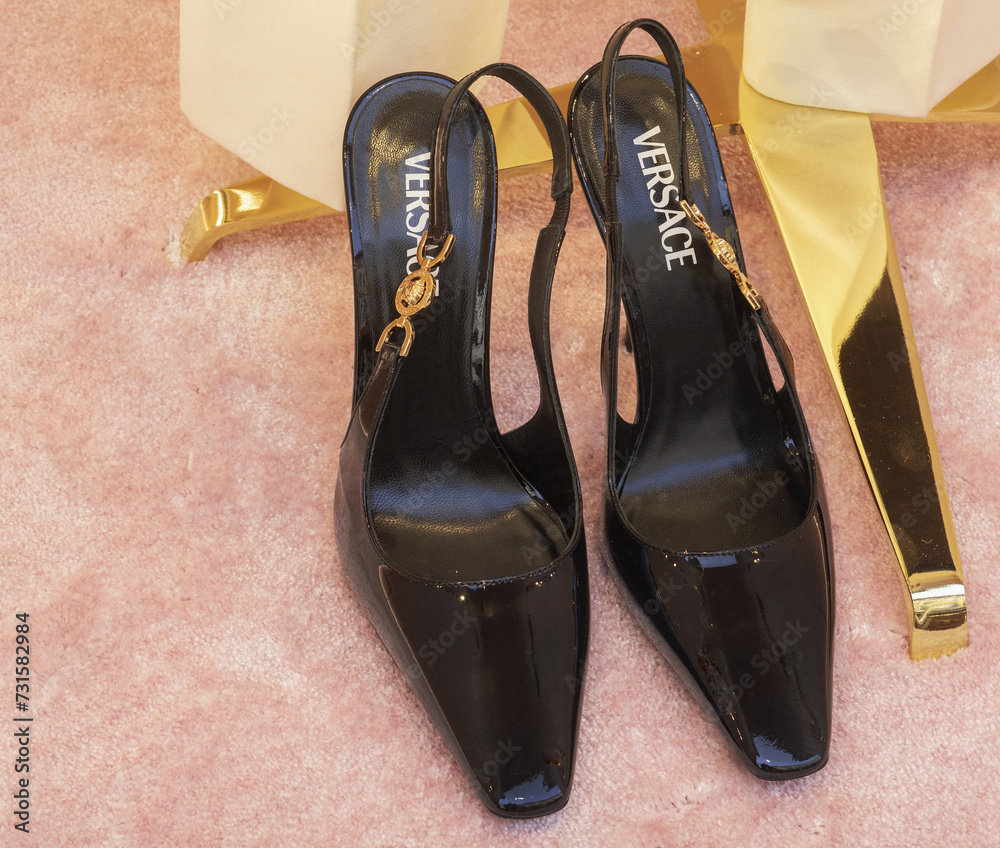 Stylish black patent leather slingbacks with golden Versace logo clasp ...