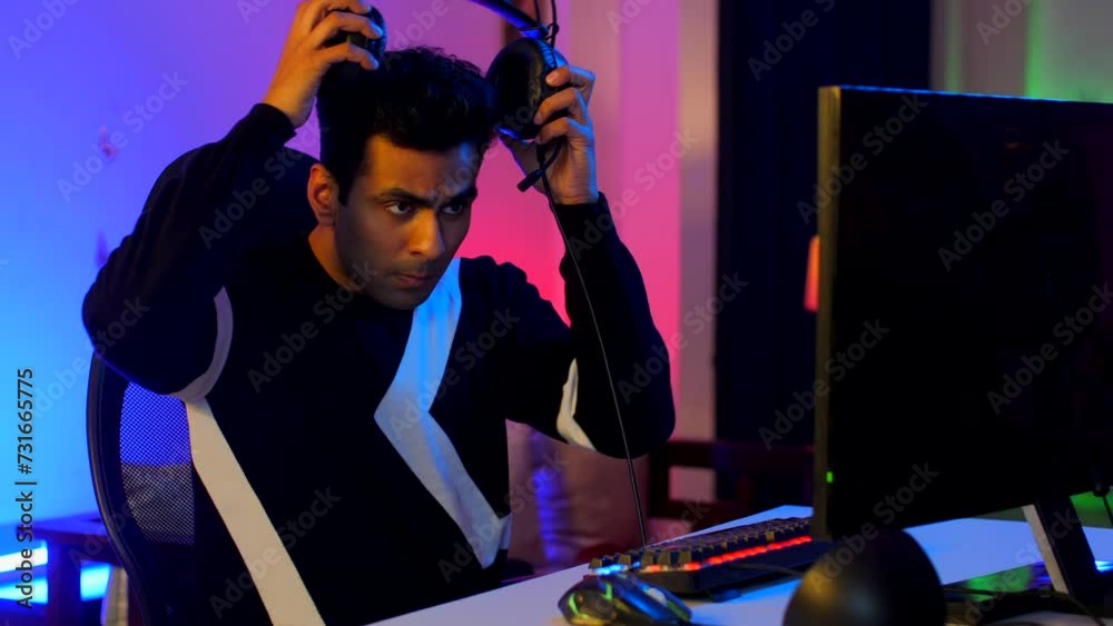 A professional Indian gamer puts on headphones and starts playing ...