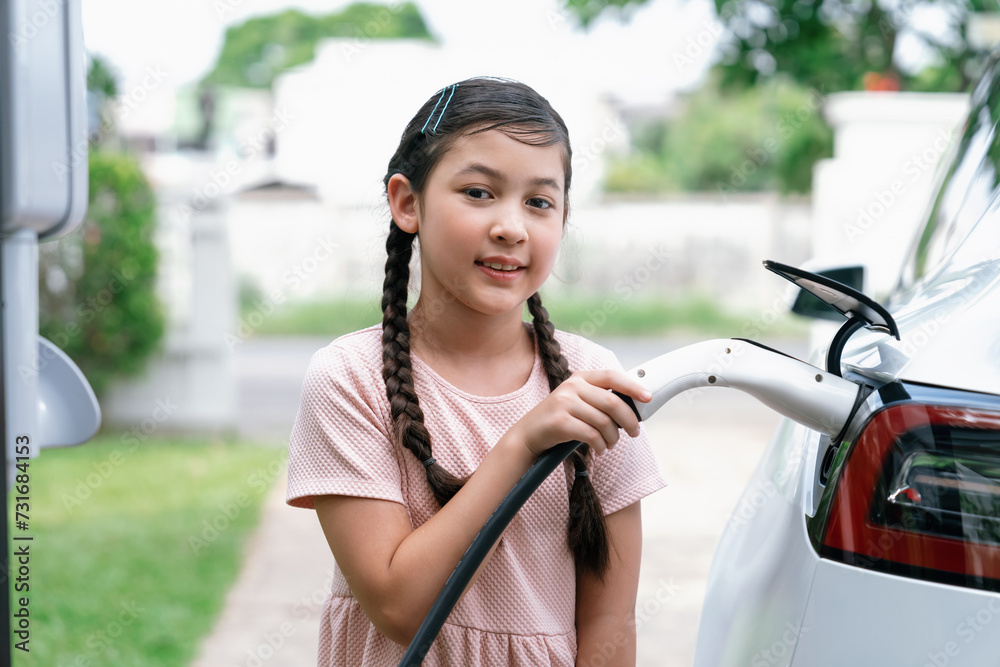 Happy little young girl learn about eco-friendly and energy ...