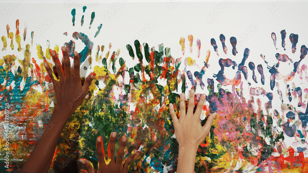 Happy diverse student hand placed on colorful stained wall. Closeup of ...